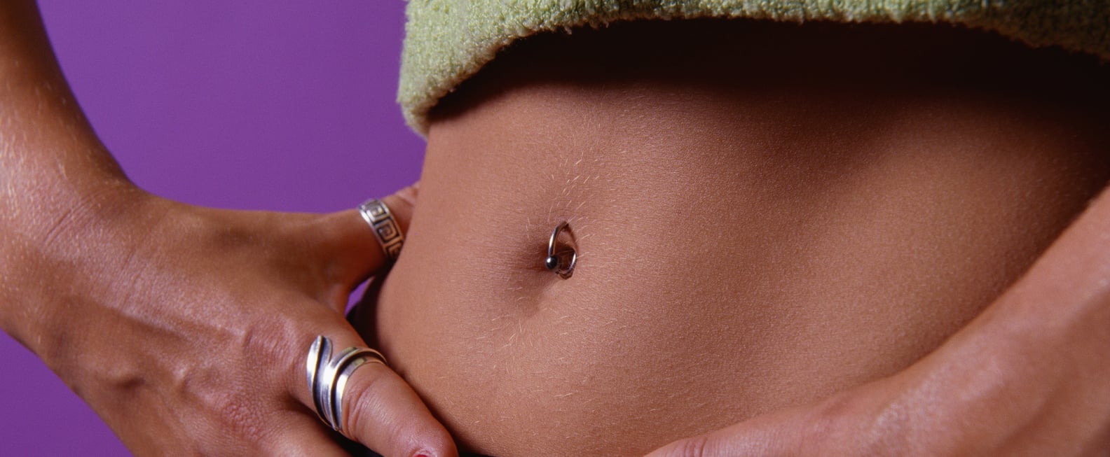 What to Know About “Floating" Belly Button Piercings | PS UK Beauty
