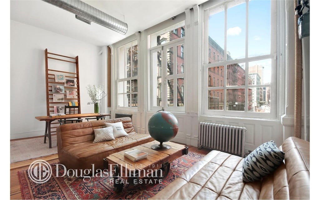 Massive windows ascend to the top of the 13-foot ceilings, filling ...