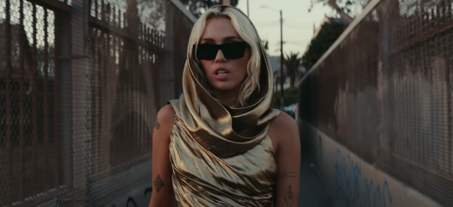 Miley Cyrus Wears Gold Cutout Dress in "Flowers" Music Video | PS Fashion